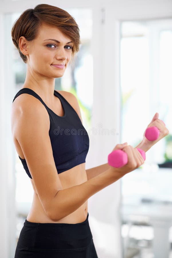 Toning Her Biceps. a Woman Working Out with a Dumbbells. Stock Photo ...