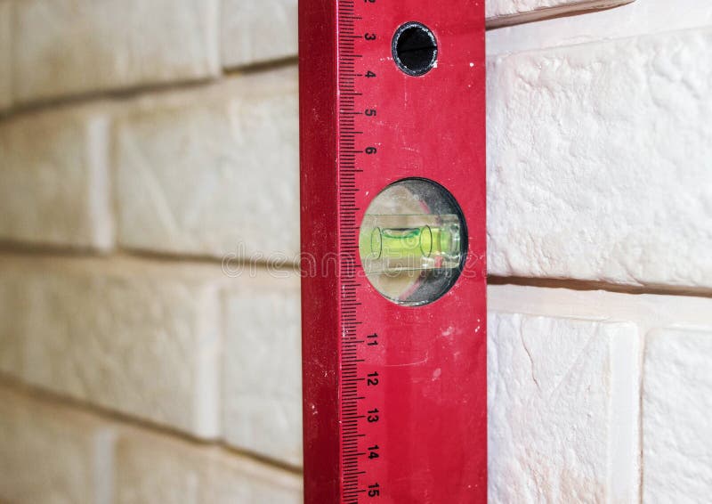 Man Measuring Brick Wall Indoors. Construction Tool Stock Image - Image ...