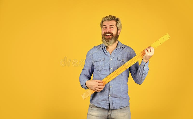 Measuring with Ruler. School Teacher Hold Ruler Yellow Background ...