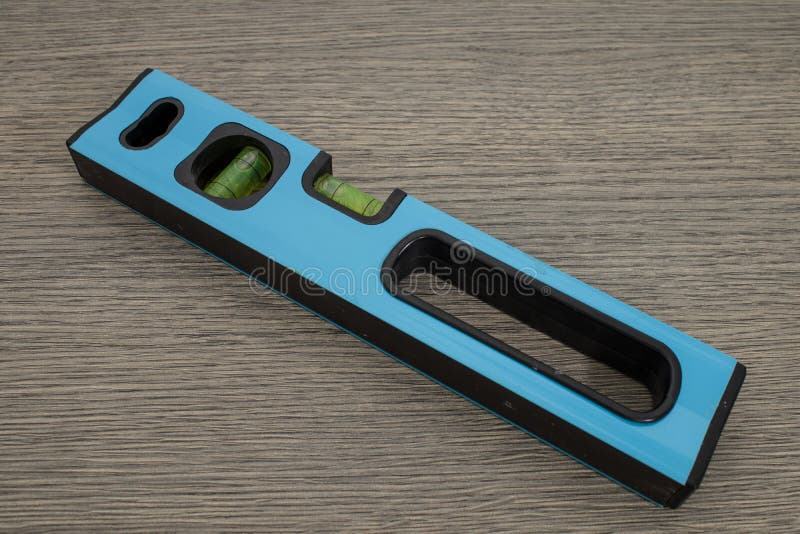 Tools, Blue Bubble Level on a Decorated Wood Table Stock Image - Image ...