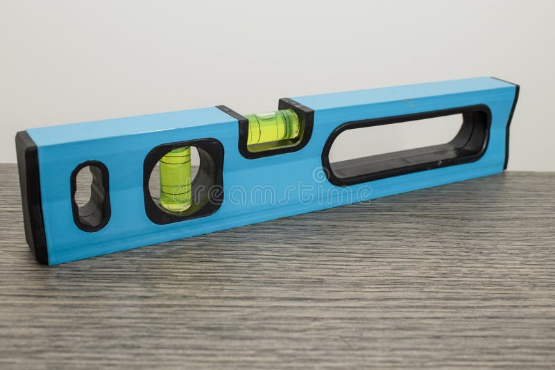 Tools, Blue Bubble Level on a Decorated Wood Table Stock Image - Image ...