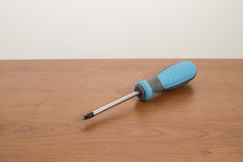 Tools, Blue Screwdriver on a Walnut Table Stock Photo - Image of ...