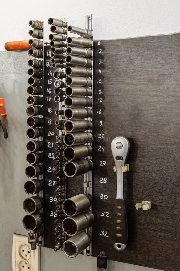 Tools on the Board. Spanners Hanging on Wall in Workshop Stock Photo ...