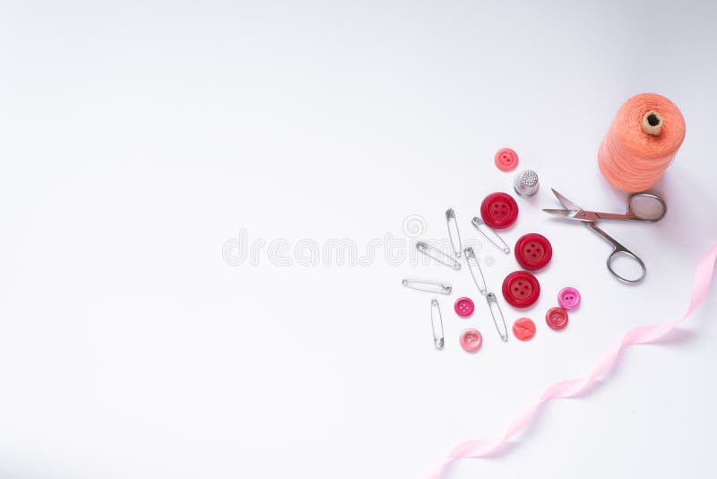 Sewing Materials - a Box with Threads of Bright Colors, a Pink Ribbon ...