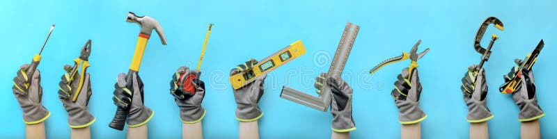 Tools in Hand. Hands Hold Construction and Carpentry Tools, on a Blue ...