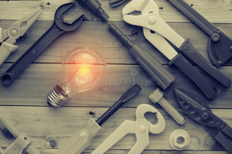 Tools and Instruments Toys with Light Bulb on Wood Texture Stock Image ...