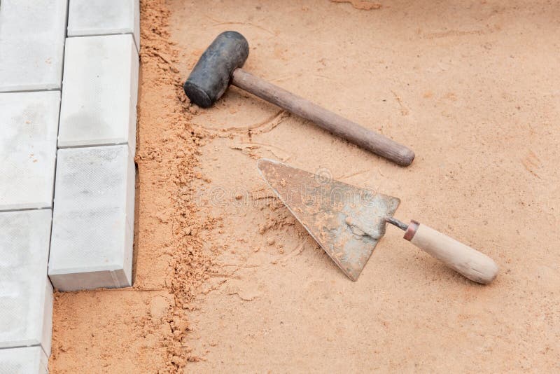 Tools of the Mason on a Sand - Trowel and Hammer Stock Photo - Image of ...