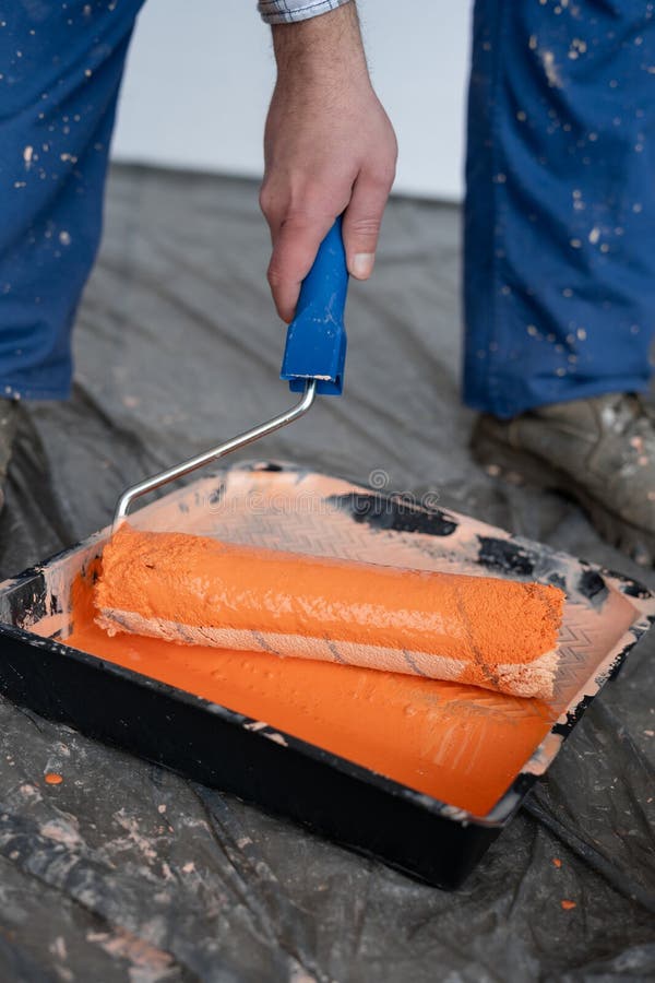 Tools for the Painter and Redecoration. Close-up of Orange Paint and ...