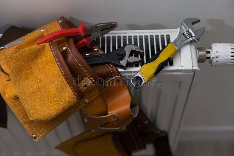 Tools on the Radiator. Water Heating Radiator on the White Wall Indoors ...