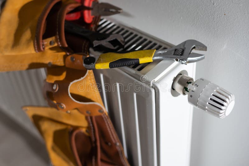 Tools on the Radiator. Water Heating Radiator on the White Wall Indoors ...