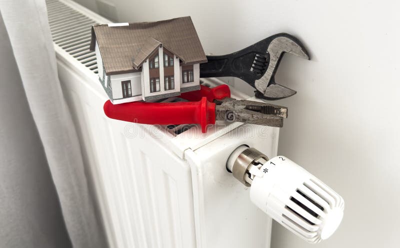 Tools on the Radiator. Water Heating Radiator on the White Wall Indoors ...