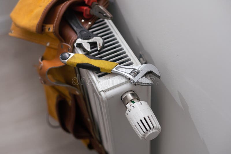 Tools on the Radiator. Water Heating Radiator on the White Wall Indoors ...