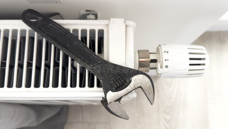 Tools on the Radiator. Water Heating Radiator on the White Wall Indoors ...