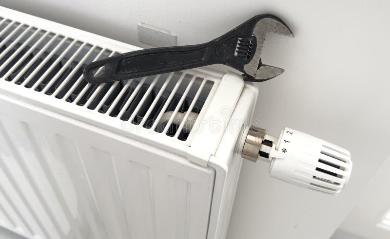 Tools on the Radiator. Water Heating Radiator on the White Wall Indoors ...