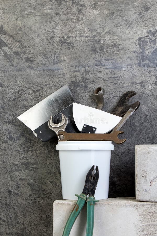 Tools for Repair in a Construction Bucket, Bricks on a Gray Concrete ...