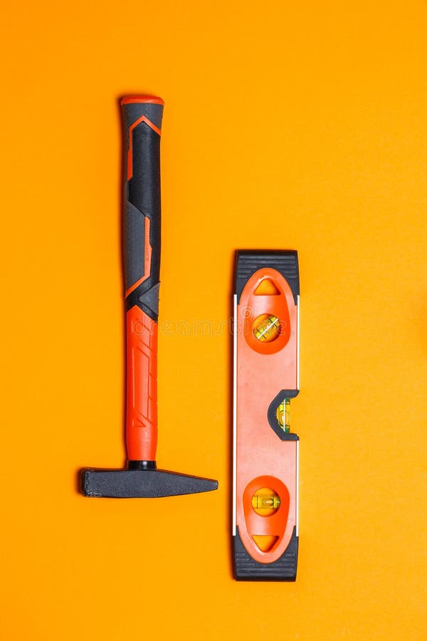 Tools for Repair. Hammer for Nails and Level on an Orange Background ...