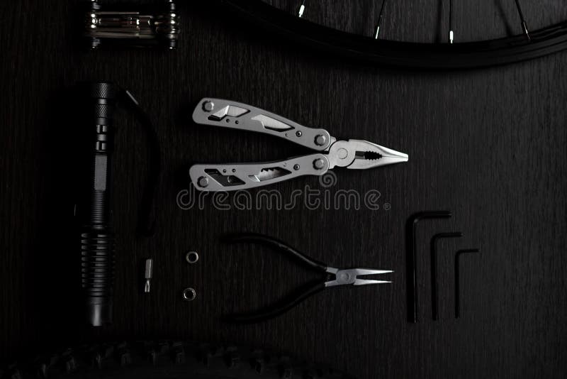 Tools on the Table. Spoked Wheel, Tire, Hex Keys, Brake Disc, Multitool ...