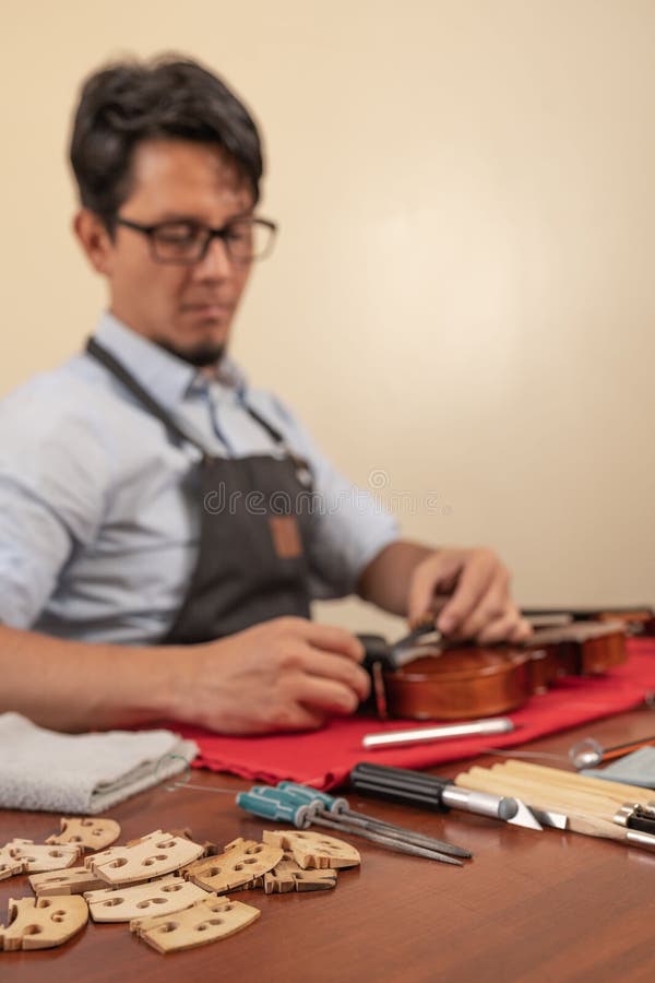 Tools To Repair an Instrument Next To Violin Bridges on a Workshop ...