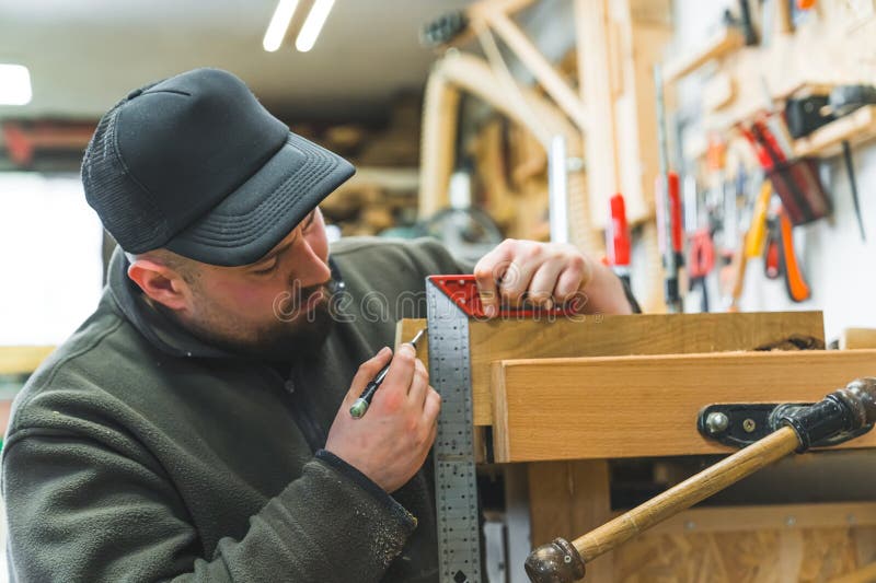 Tools in Woodworking Process. Focused Craftsman Using Bracket and ...
