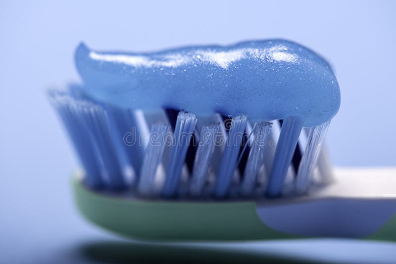 Toothbrush with Blue Toothpaste on a Blue Blurred Background Stock ...
