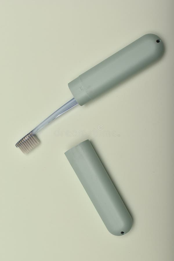 A Toothbrush Case and a Toothbrush on a Green Background Stock Image ...