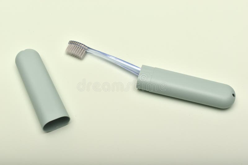 A Toothbrush Case and a Toothbrush on a Green Background Stock Photo ...