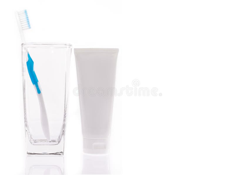 Toothbrush in a Clear Glass and Toothpaste on White Background Stock ...