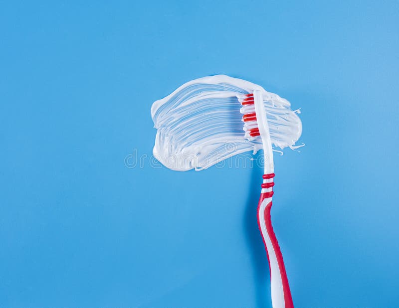 A Toothbrush with a Little Smeared Toothpaste and White Toothpaste ...
