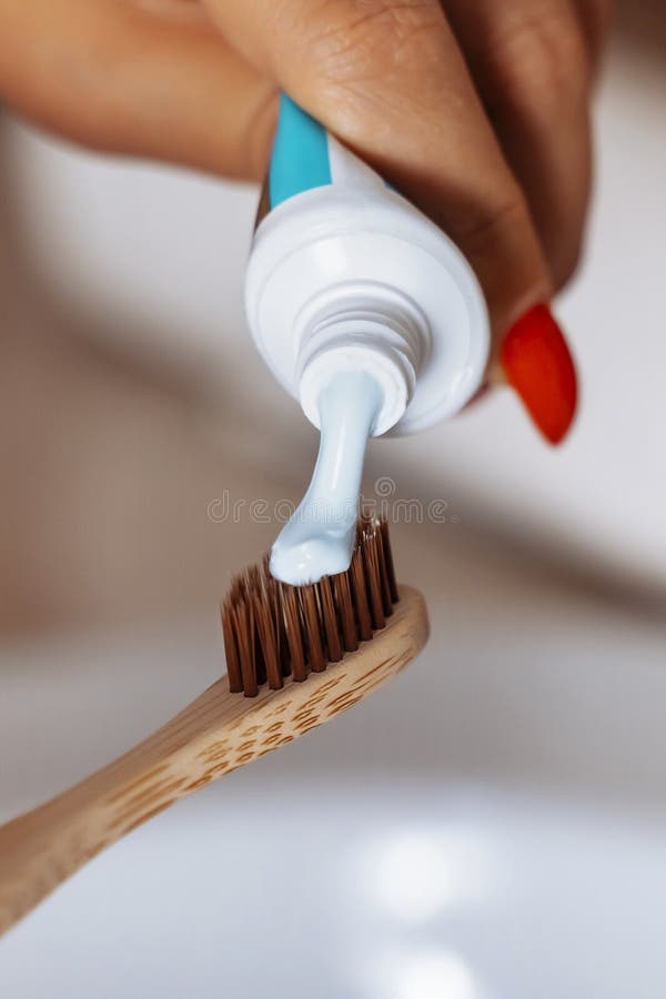Toothbrush and Toothpaste on Blurred Background. Closeup. Wooden ...