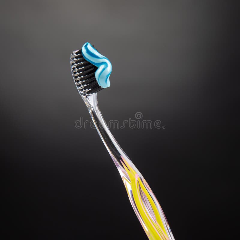 Toothbrush with Toothpaste for Cleaning Teeth on a Dark Background ...