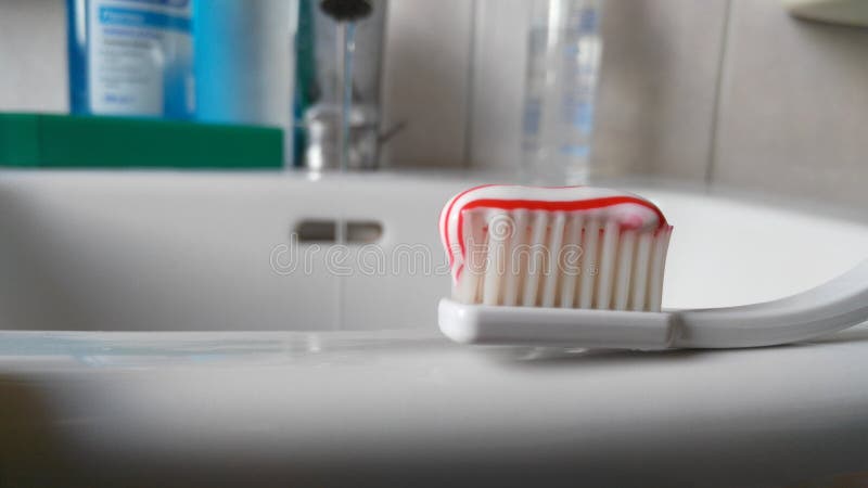 Toothbrush with Toothpaste on a Sink Stock Photo - Image of clean ...