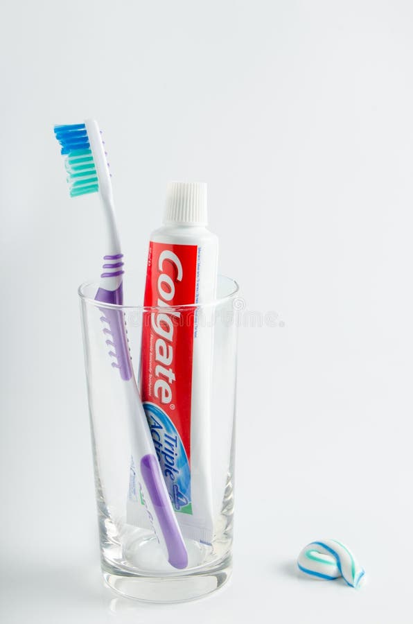 Toothbrush and Tube of Toothpaste in a Glass Editorial Image - Image of ...
