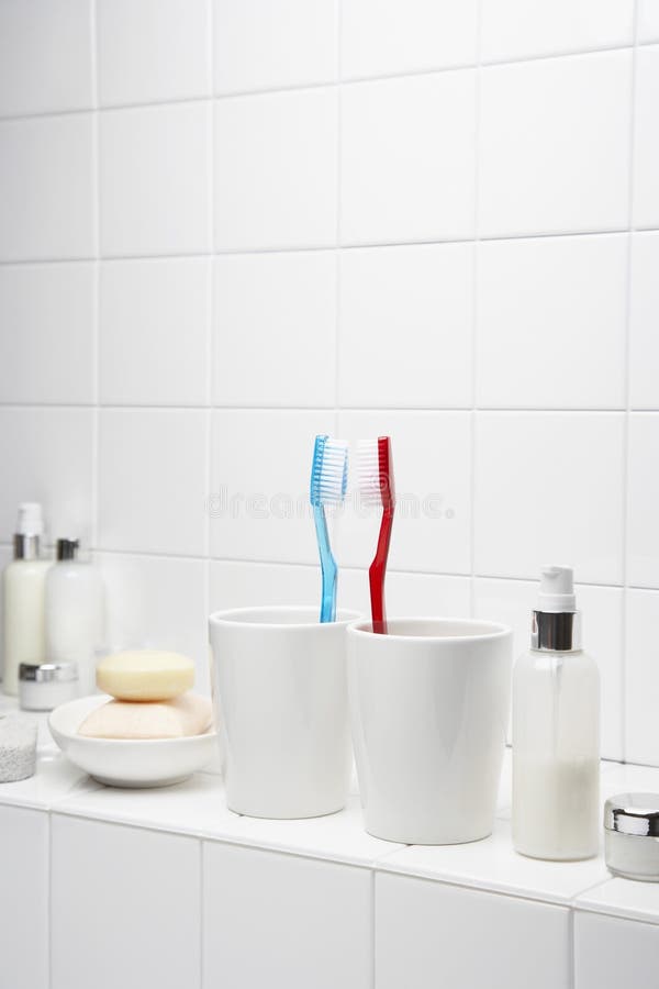 Toothbrushes Face To Face on Shelf in White Bathroom Stock Photo ...