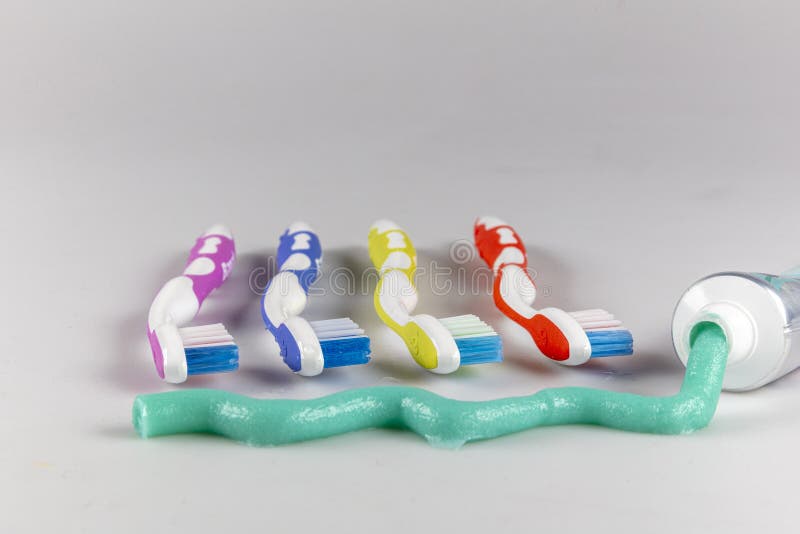 Green Toothpaste and Multicolored Toothbrushes To a Tube of Toothpaste ...