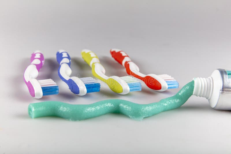 Green Toothpaste and Multicolored Toothbrushes To a Tube of Toothpaste ...