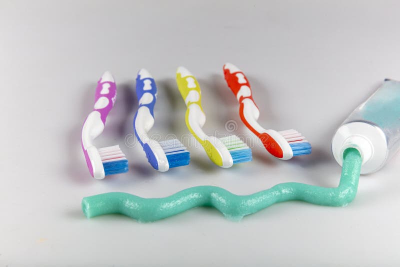 Green Toothpaste and Multicolored Toothbrushes To a Tube of Toothpaste ...