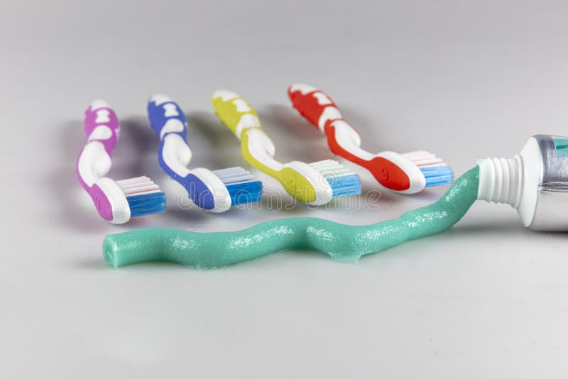 Green Toothpaste and Multicolored Toothbrushes To a Tube of Toothpaste ...