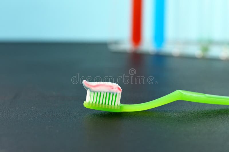 Toothpaste Applied To the Toothbrush on Background of the Chemical ...