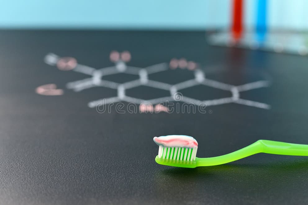 Toothpaste Applied To the Toothbrush on Background of the Chemical ...