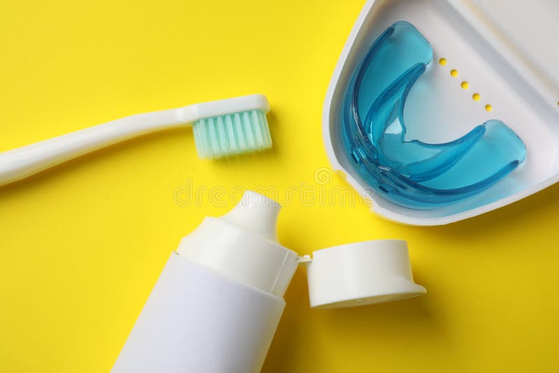 Toothpaste, Brush and Dental Mouth Guard on Yellow Background, Flat Lay ...