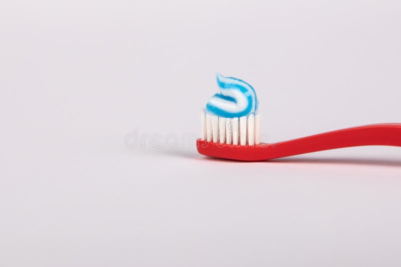 Toothpaste on a Red Toothbrush. Oral Hygiene and Health Concept Stock ...