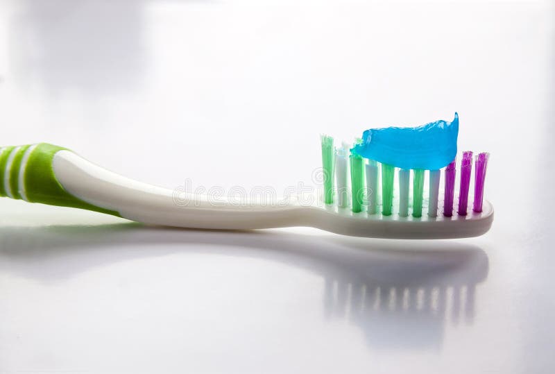 Toothpaste on a Toothbrush Close-up on a White Light Background Stock ...