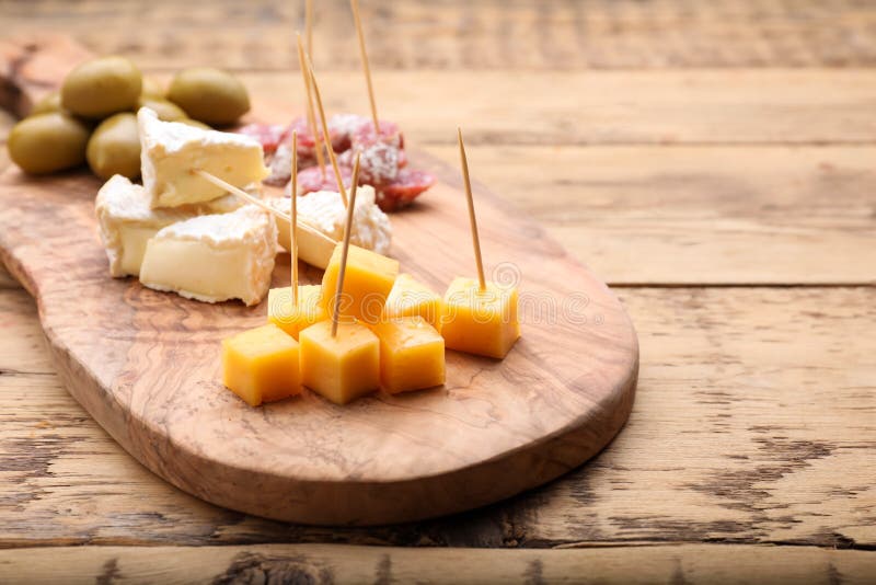 Toothpick Appetizers. Pieces of Different Cheese on Wooden Table ...
