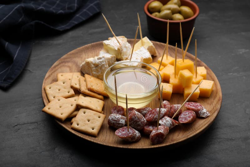 Toothpick Appetizers. Pieces of Sausage, Crackers and Honey on Black ...