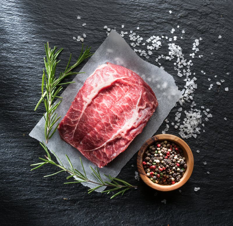 The Top Blade Steak or Beef Steak on the Graphite Board with Herbs and ...
