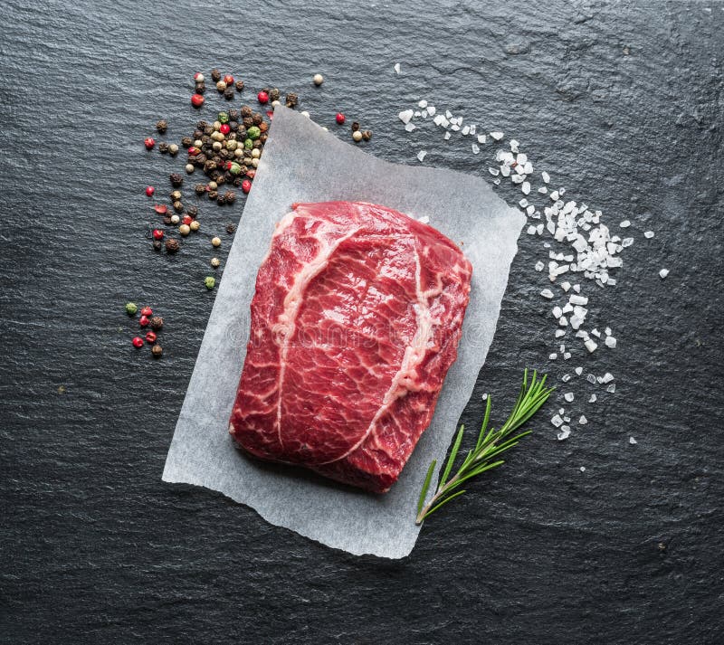 The Top Blade Steak or Beef Steak on the Graphite Board with Herbs and ...