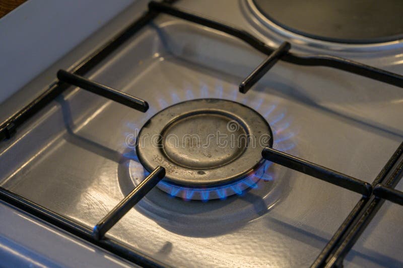 Top Closeup of a Lit Gas Hob Burner with a Gray Metallic Texture Stock ...