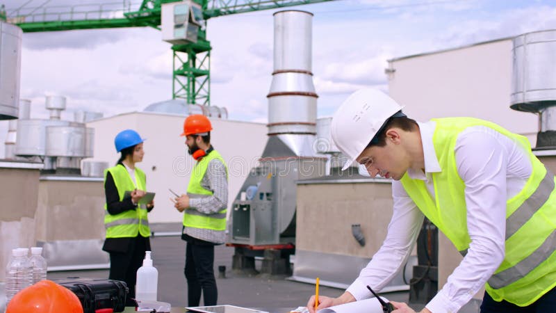 In a Top of Construction Site Engineer Man Take Some Plan of ...