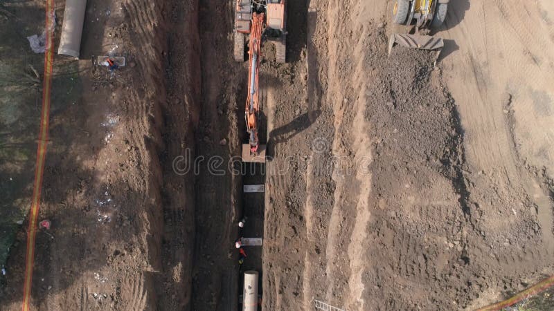 Top Down Aerial Above Construction Site with Workers and Excavator ...