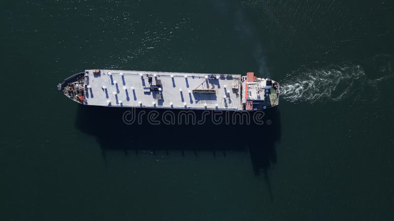 Top-down Aerial View of a Large Cargo Ship Navigating through Calm ...